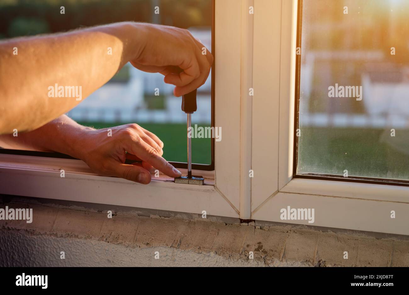 handyman adjusting white pvc plastic window indoors. homework ...