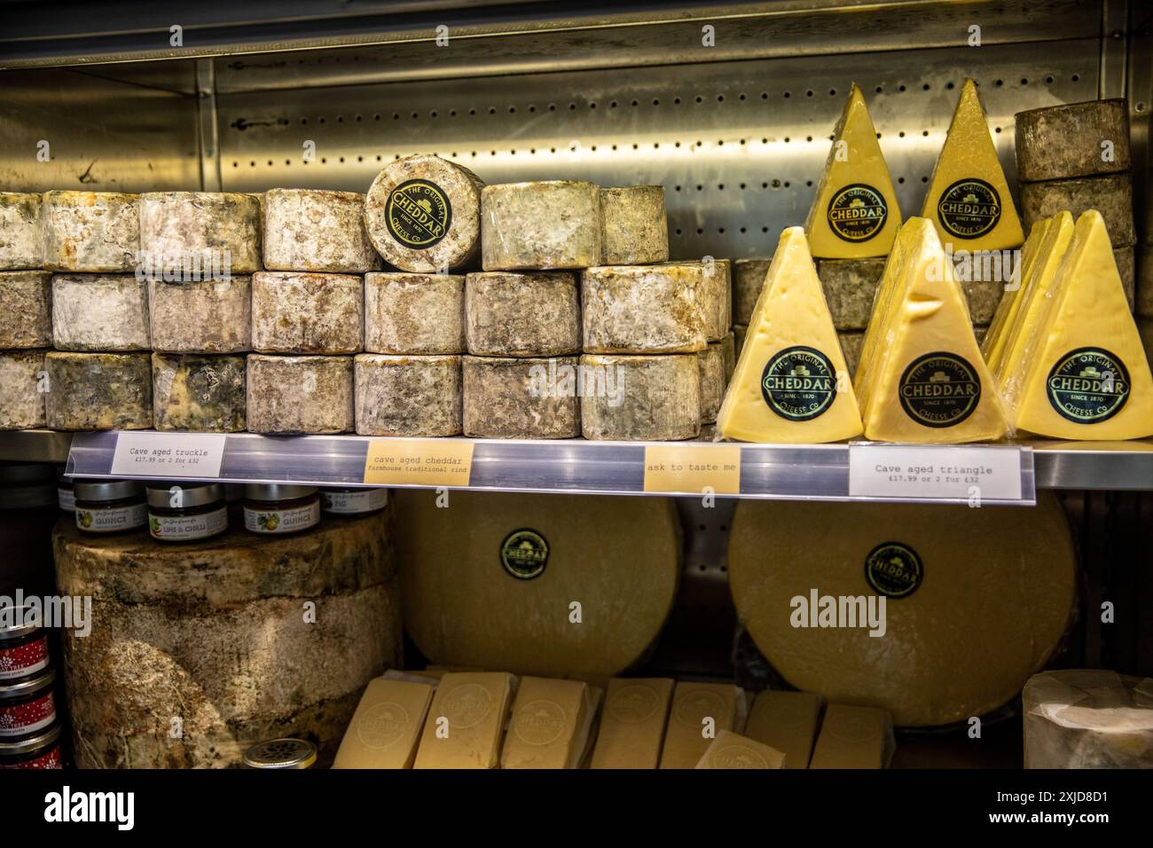 Cheddar cheeses on display inside cheese store shop in the English ...