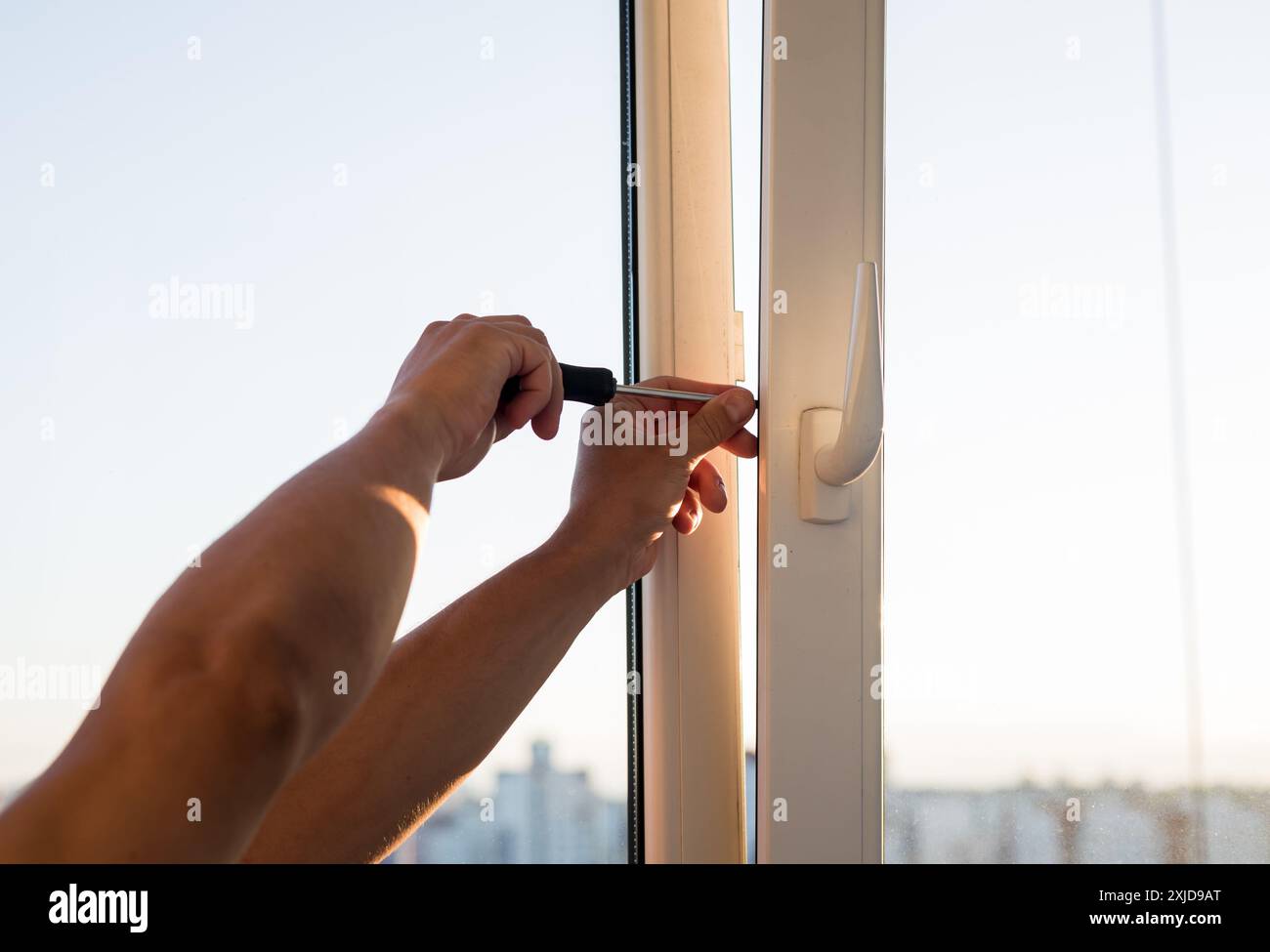 Man adjusting white pvc plastic balcony window. worker using ...