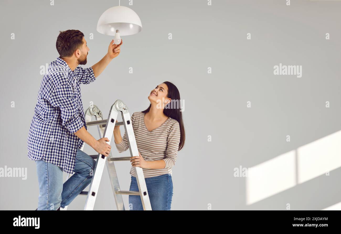 Man changing light bulb on ladder hi-res stock photography and images ...