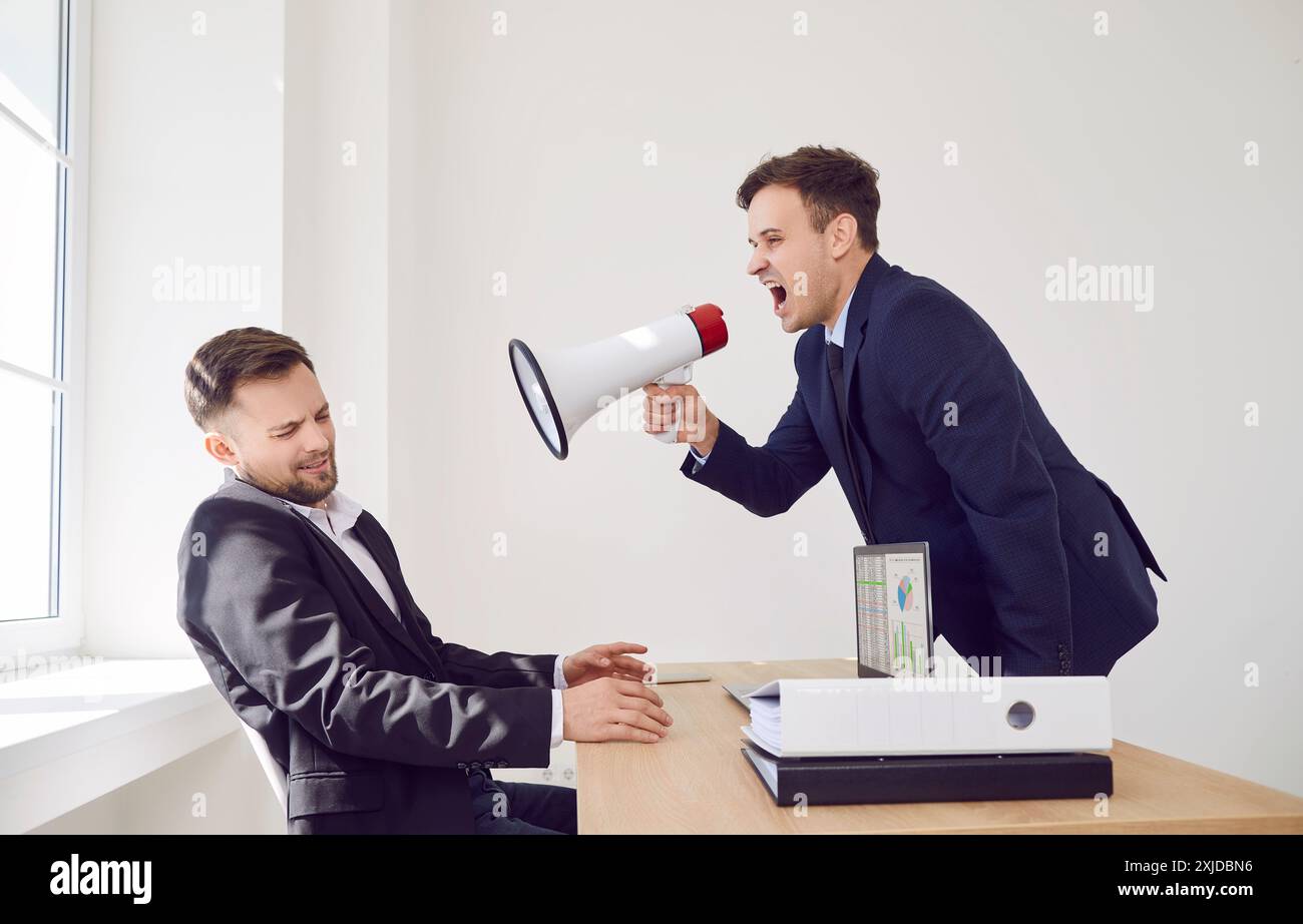 Angry boss with megaphone shouts at man in office, close-up Stock Photo ...