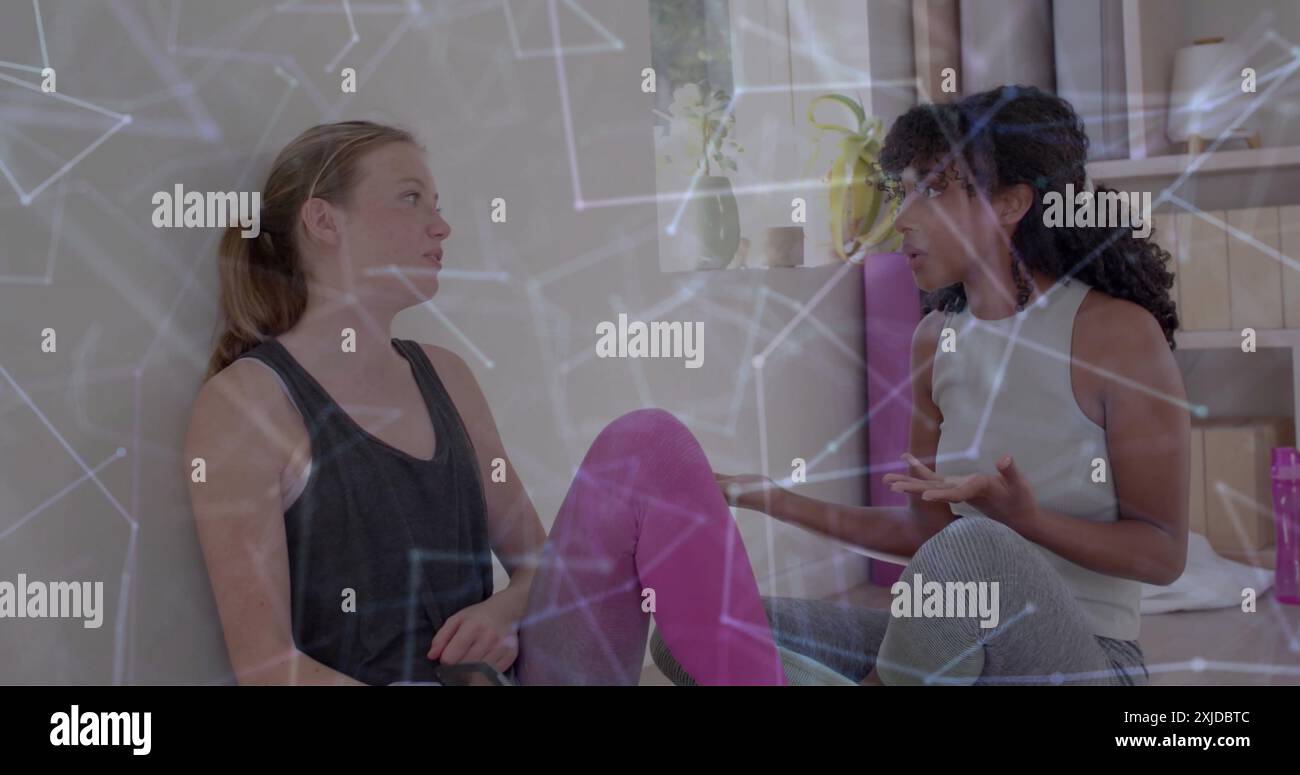 Image of communication network over happy diverse teenage girls talking ...