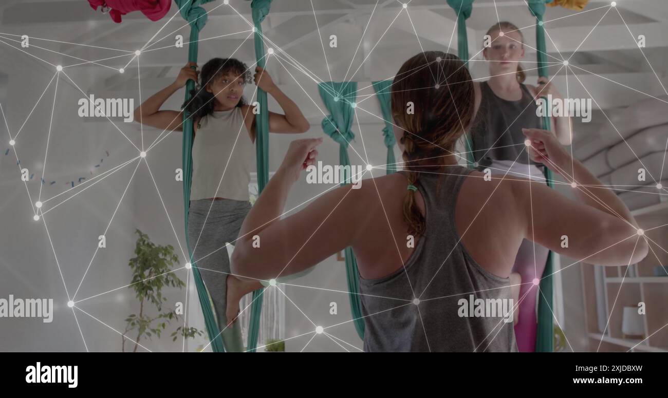 Image of network over diverse female instructor and teenager girls ...