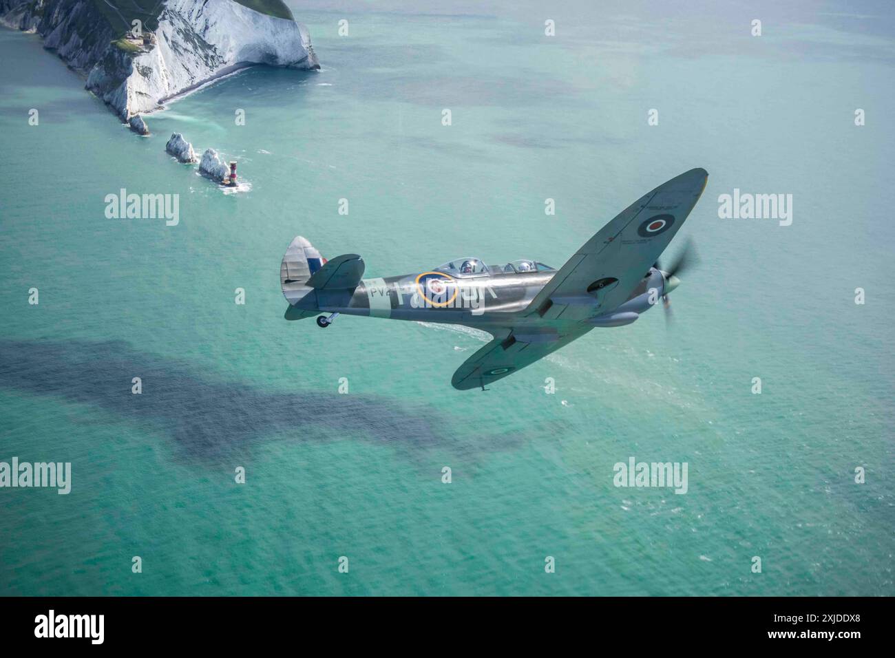 Spitfire flying around the Needles Isle of Wight Stock Photo - Alamy