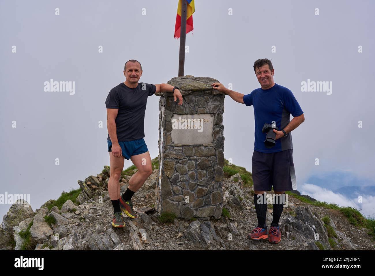 Friends standing on top of the second highest mountain in Romania ...