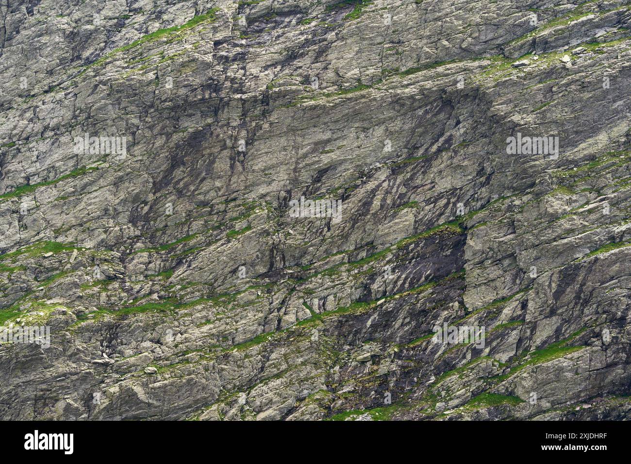 Granite rock geological layers on the face of a very old mountains ...