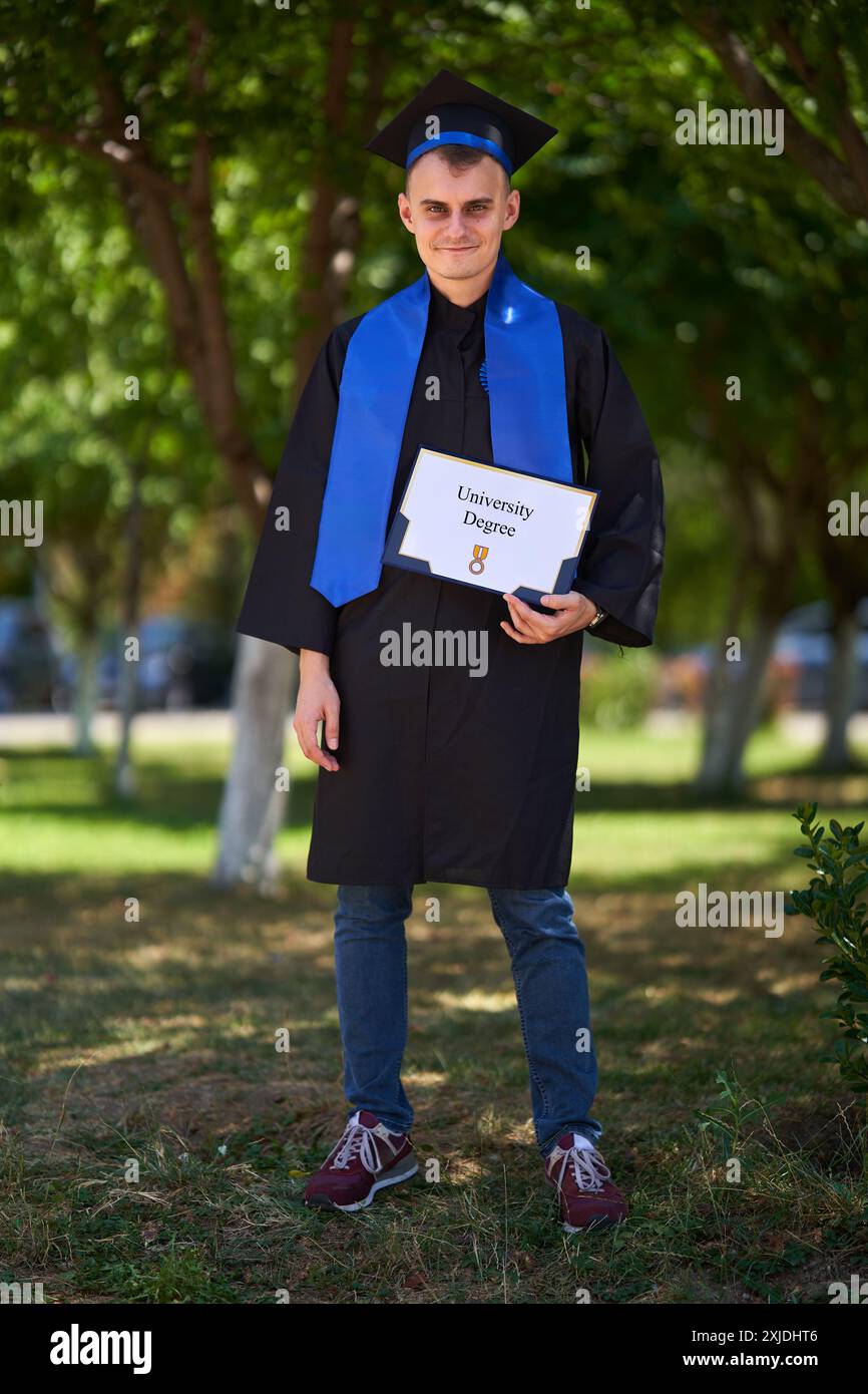 Young man university graduate in academic regalia, celebrating his ...