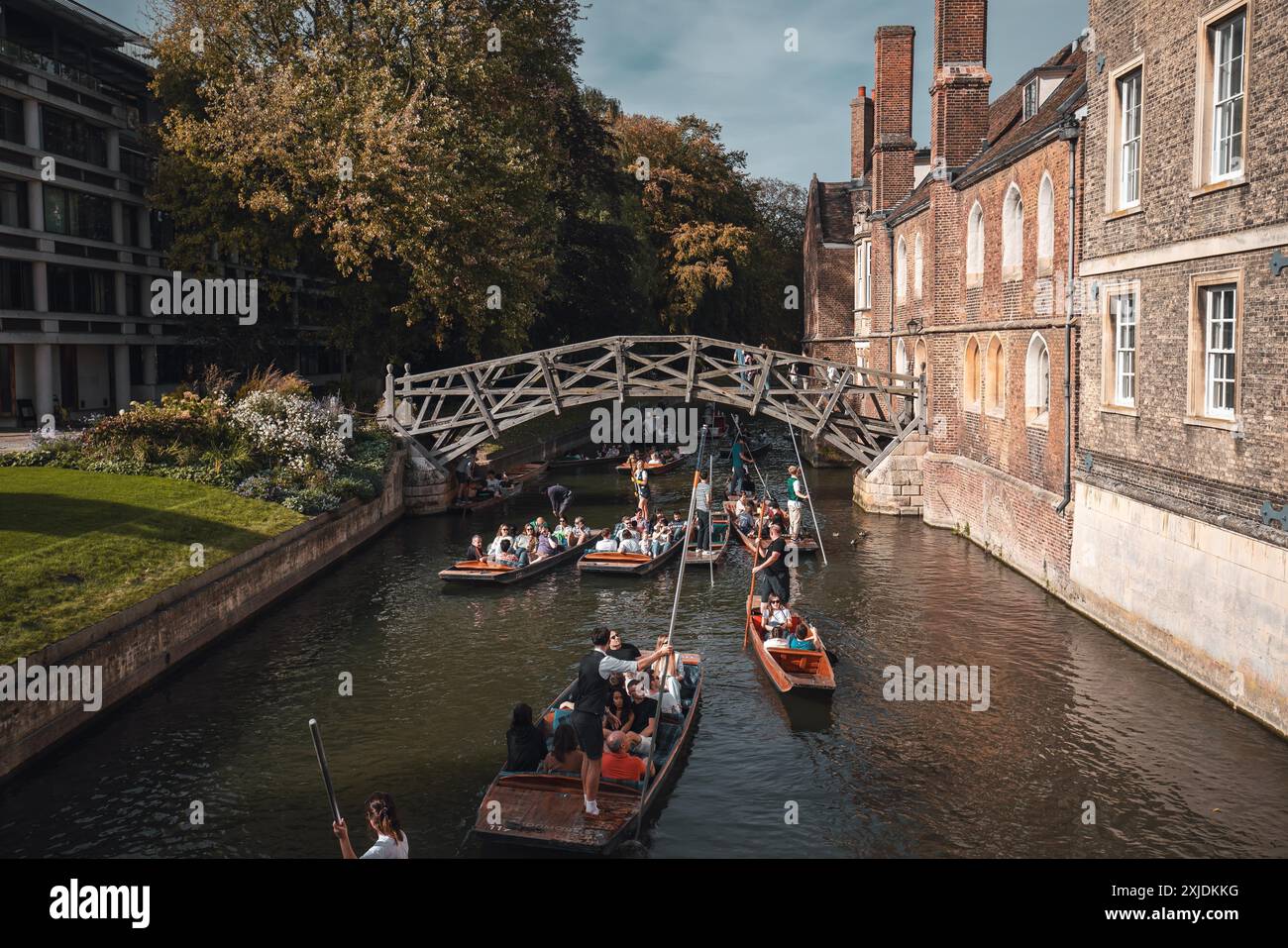 Cambridge, UK - October 08, 2023 : A wooden bridge spans a narrow river ...