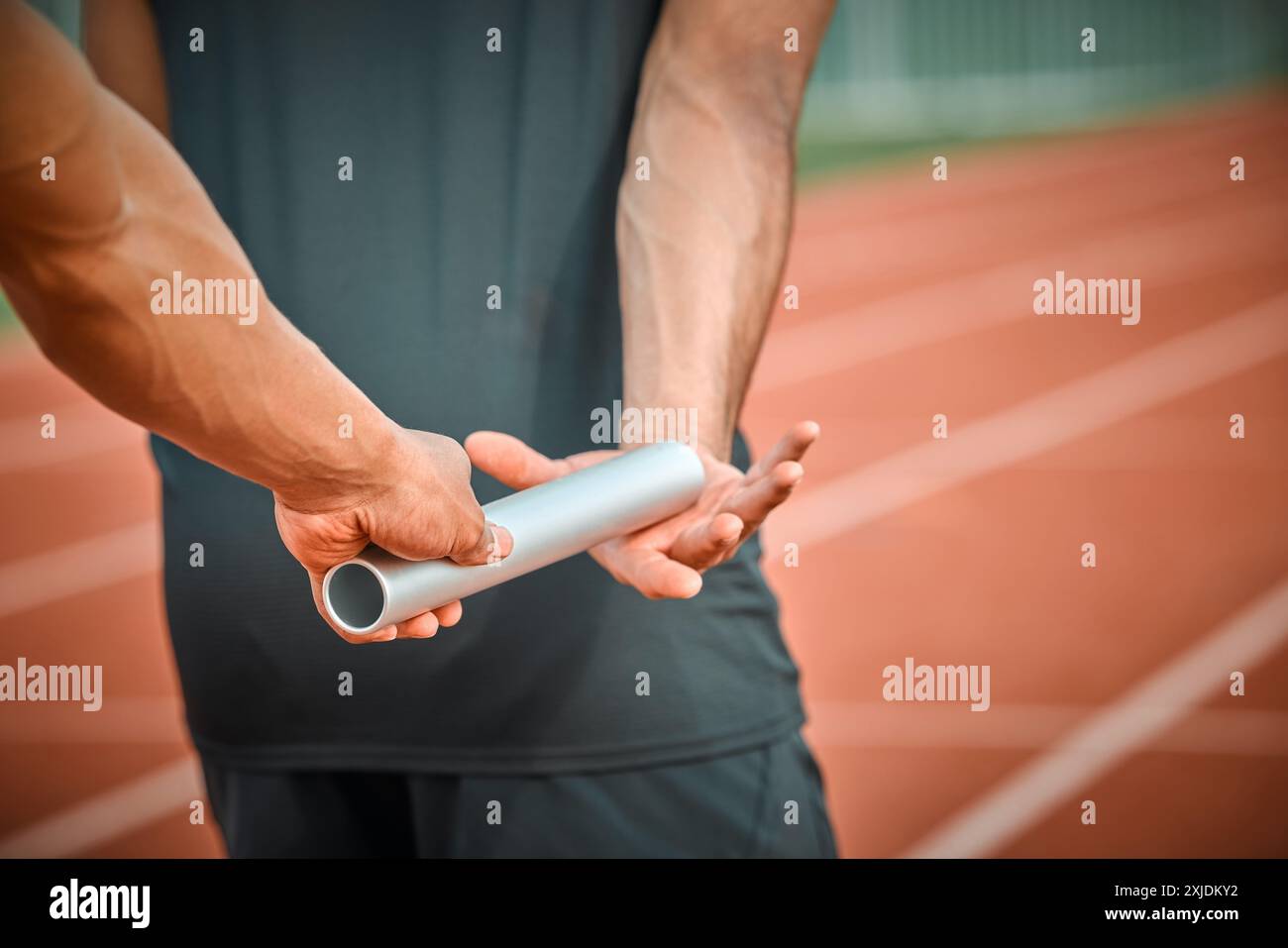 Runners passing a relay baton hi-res stock photography and images - Alamy