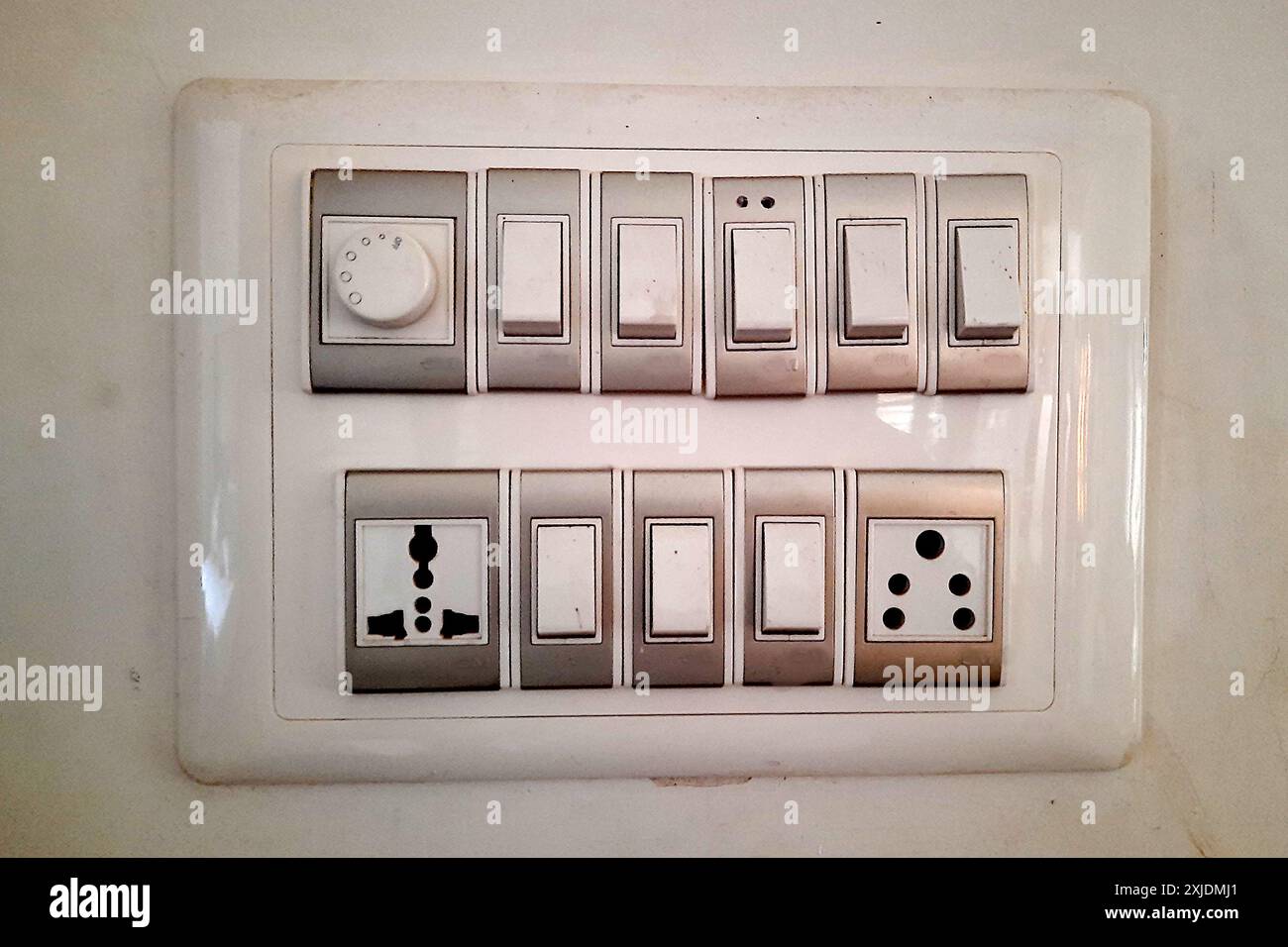 View of white, electrical switchboard containing switches, sockets and ...