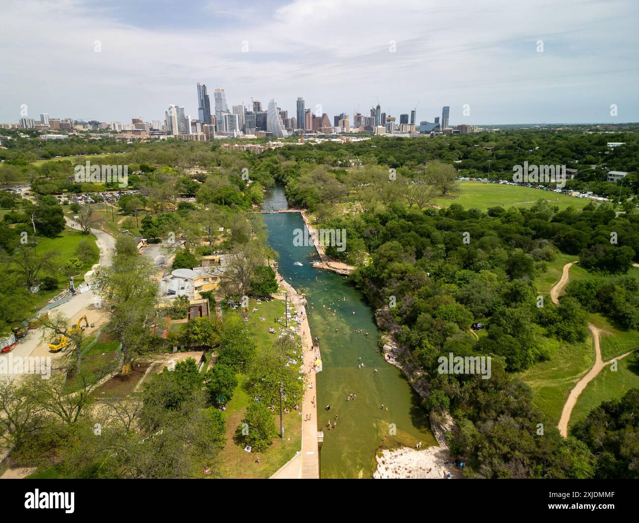 An aerial view of Barton Springs Pool in Zilker Park with the Austin ...