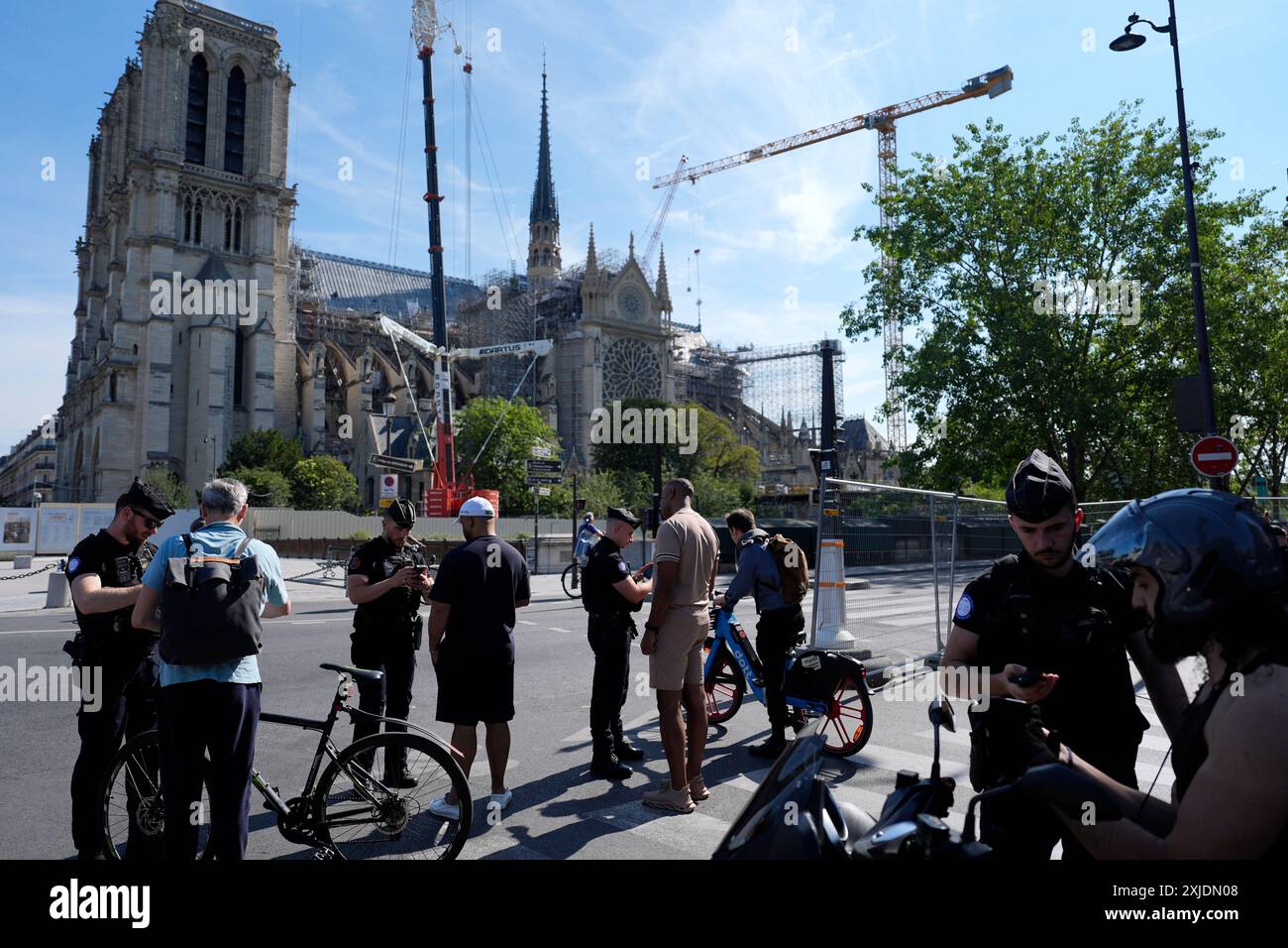 Police officers check people at the security perimeter set up for the ...