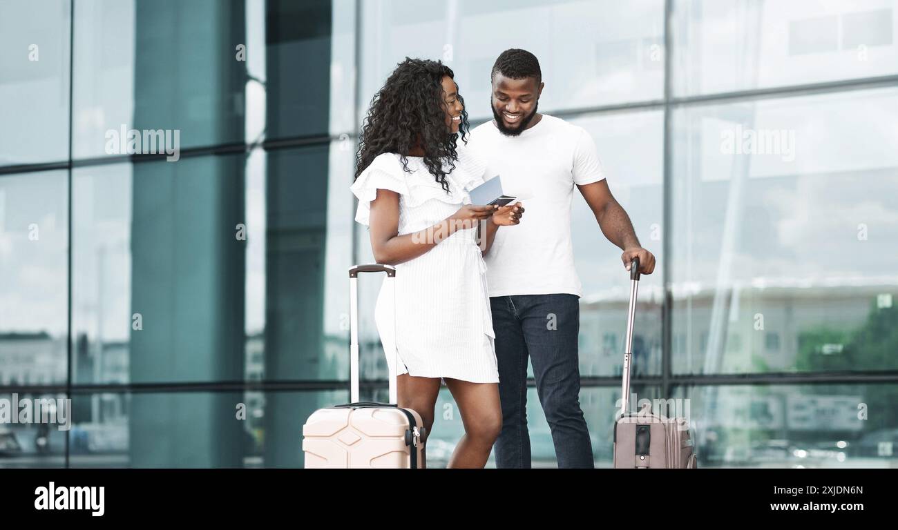 Happy Couple Checking Boarding Passes at Airport Stock Photo - Alamy
