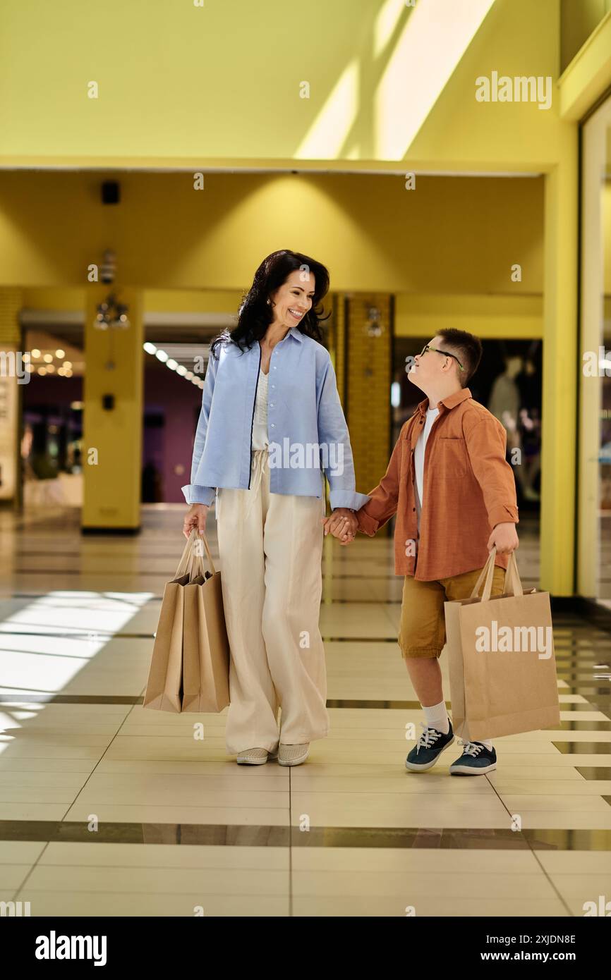 A mother and her son with Down syndrome walk through a shopping mall ...
