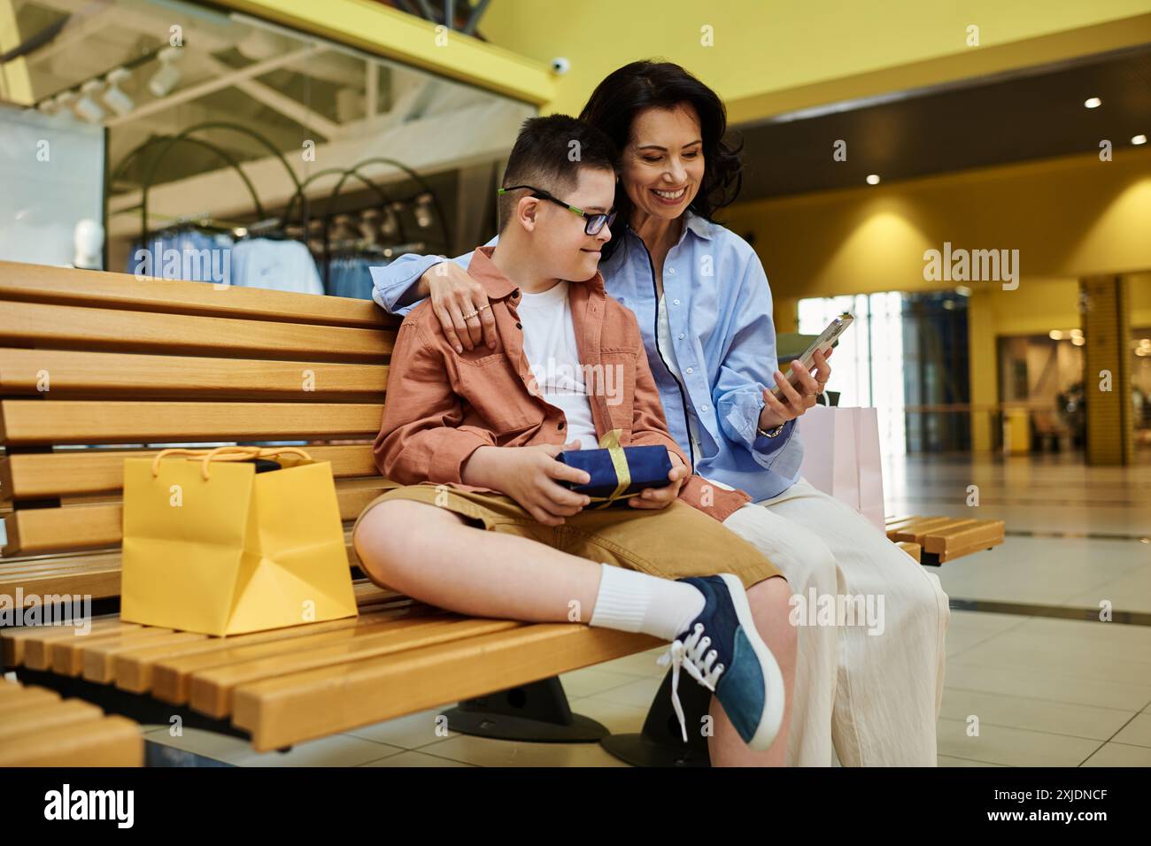 A mother and her son with Down syndrome enjoy a shopping mall outing ...