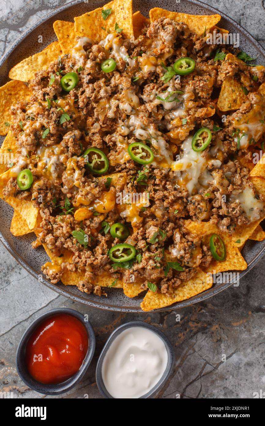 Mexican nacho corn tortilla chips with meat, cheddar cheese and ...