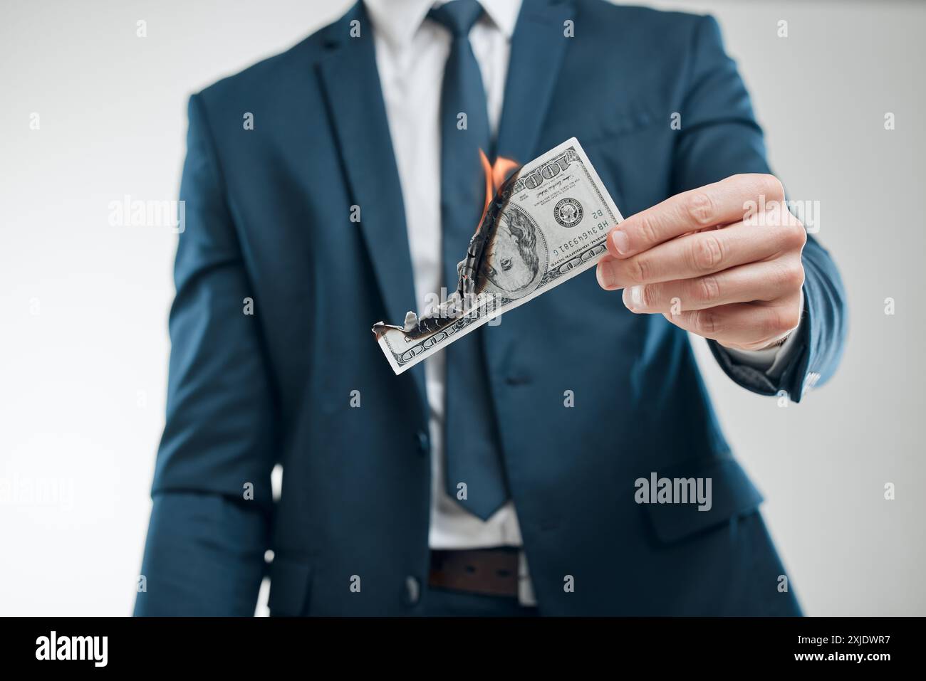 Hand, man and burning money in studio on white background for economy ...