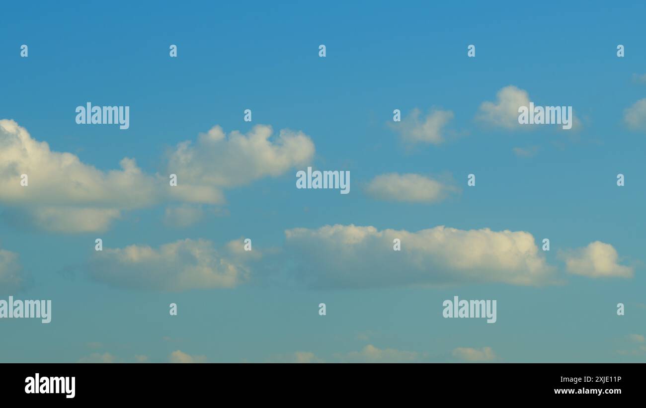 Time lapse. Fluffy curly rolling cloud in windy Summer weather. White ...