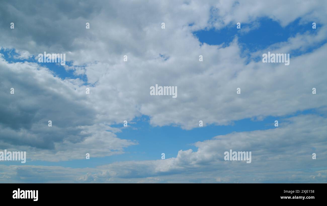 Time lapse. White clouds float across the blue sky. Puffy fluffy soft clouds Stock Photo - Alamy