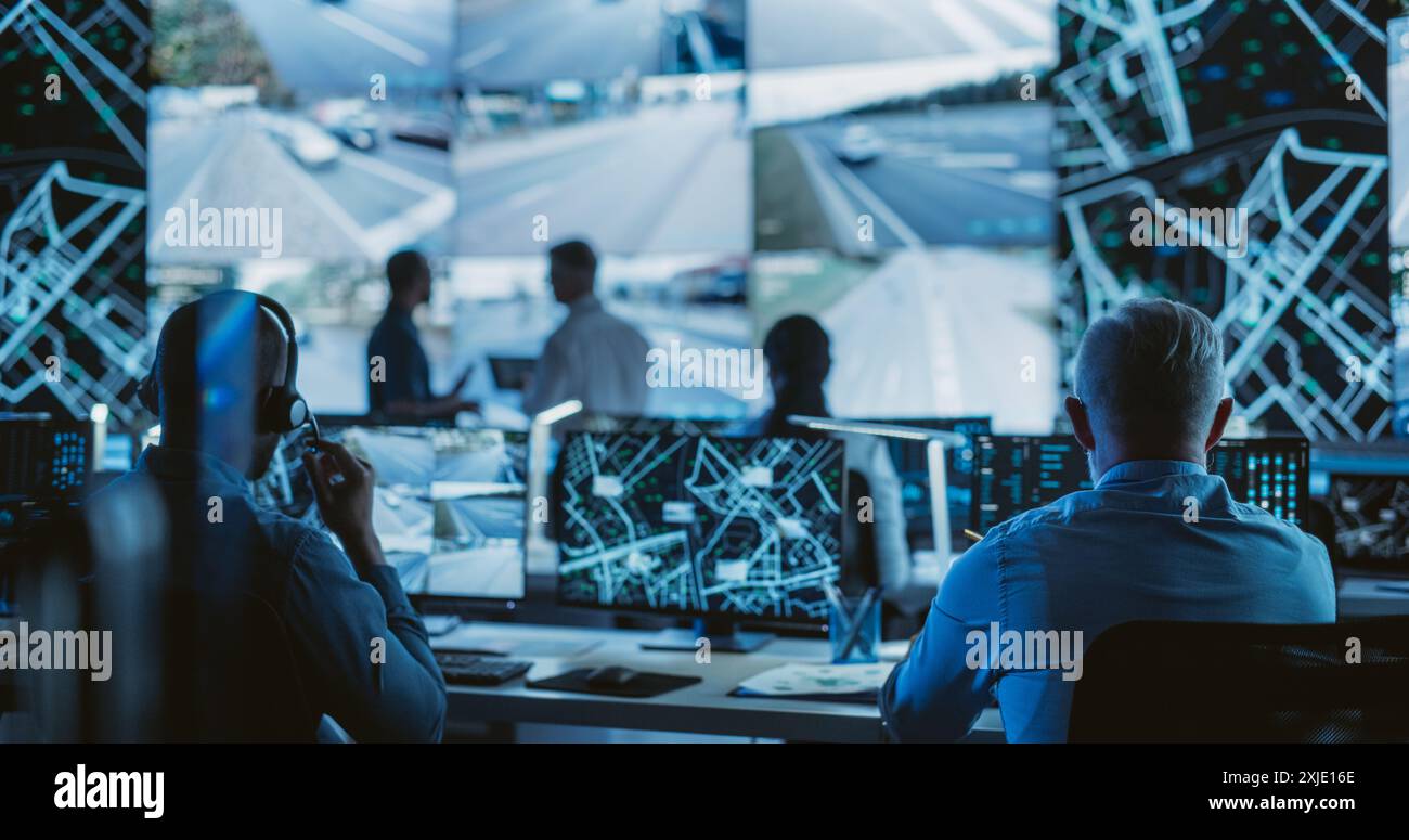 Dark Room with Multiethnic Specialists Working on Desktop Computers ...