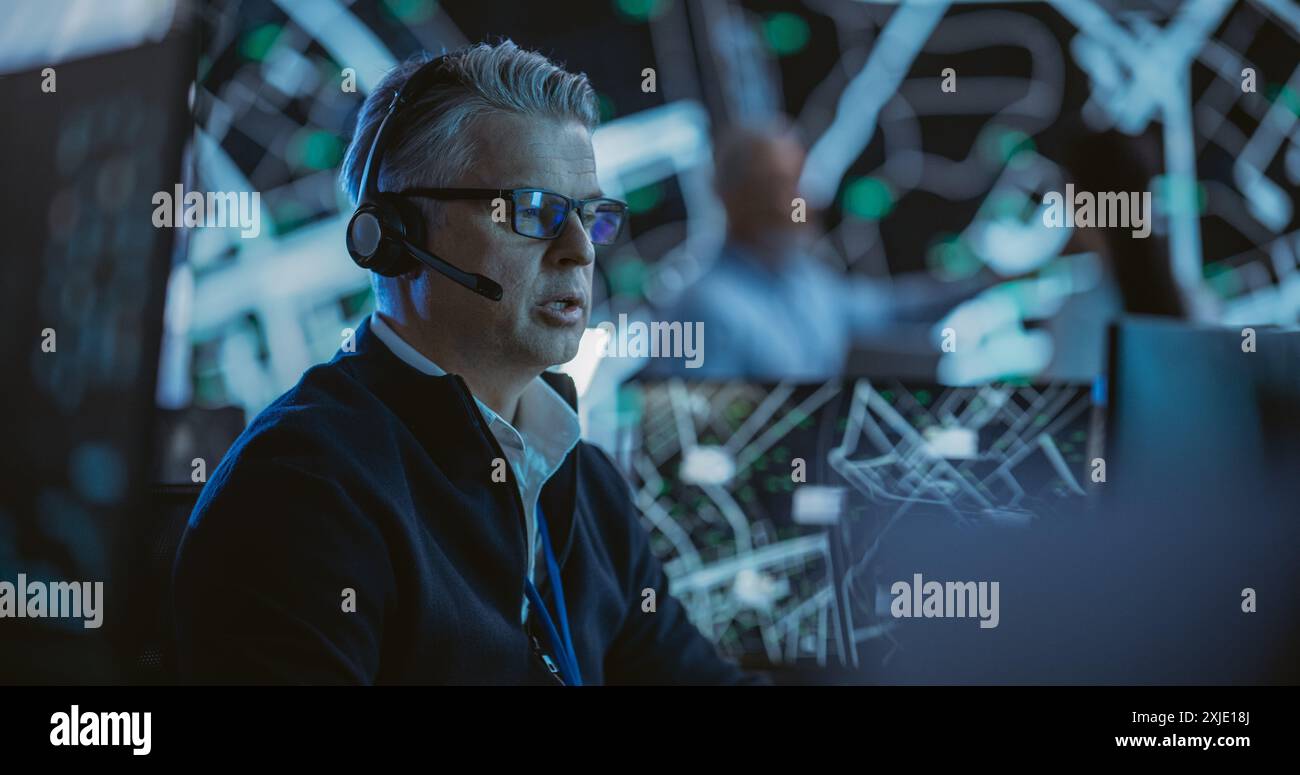 Portrait of a Middle Aged Logistics Officer Wearing a Headset, Working ...