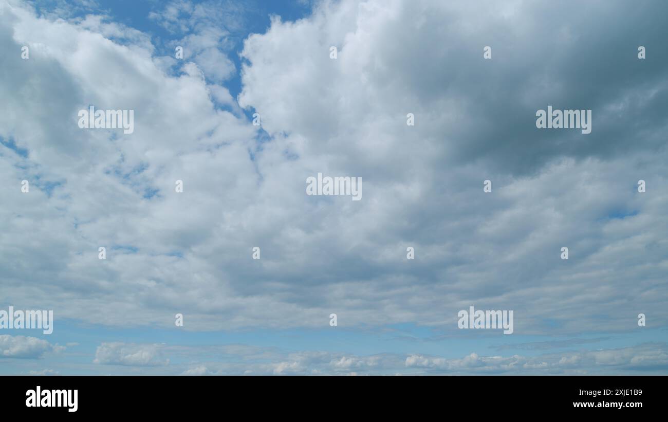 Timelapse rolling clouds on blue hi-res stock photography and images ...