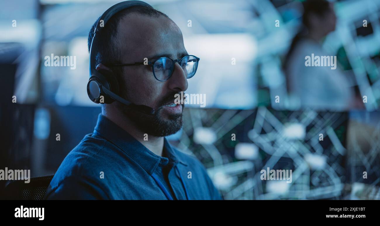 Portrait of a Surveillance Officer Wearing a Headset, Working in a ...