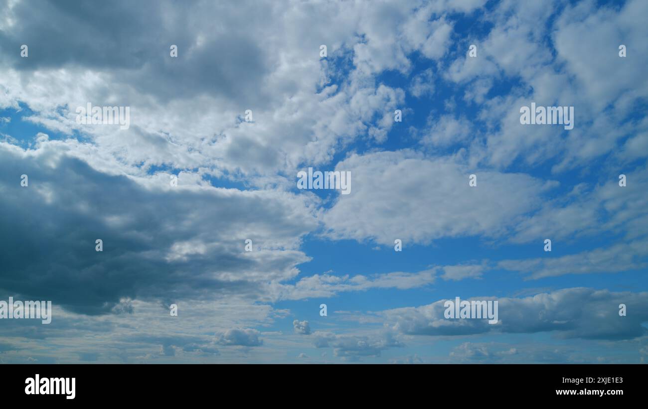 Time lapse. Fluffy curly rolling cloud in windy Summer weather. White ...