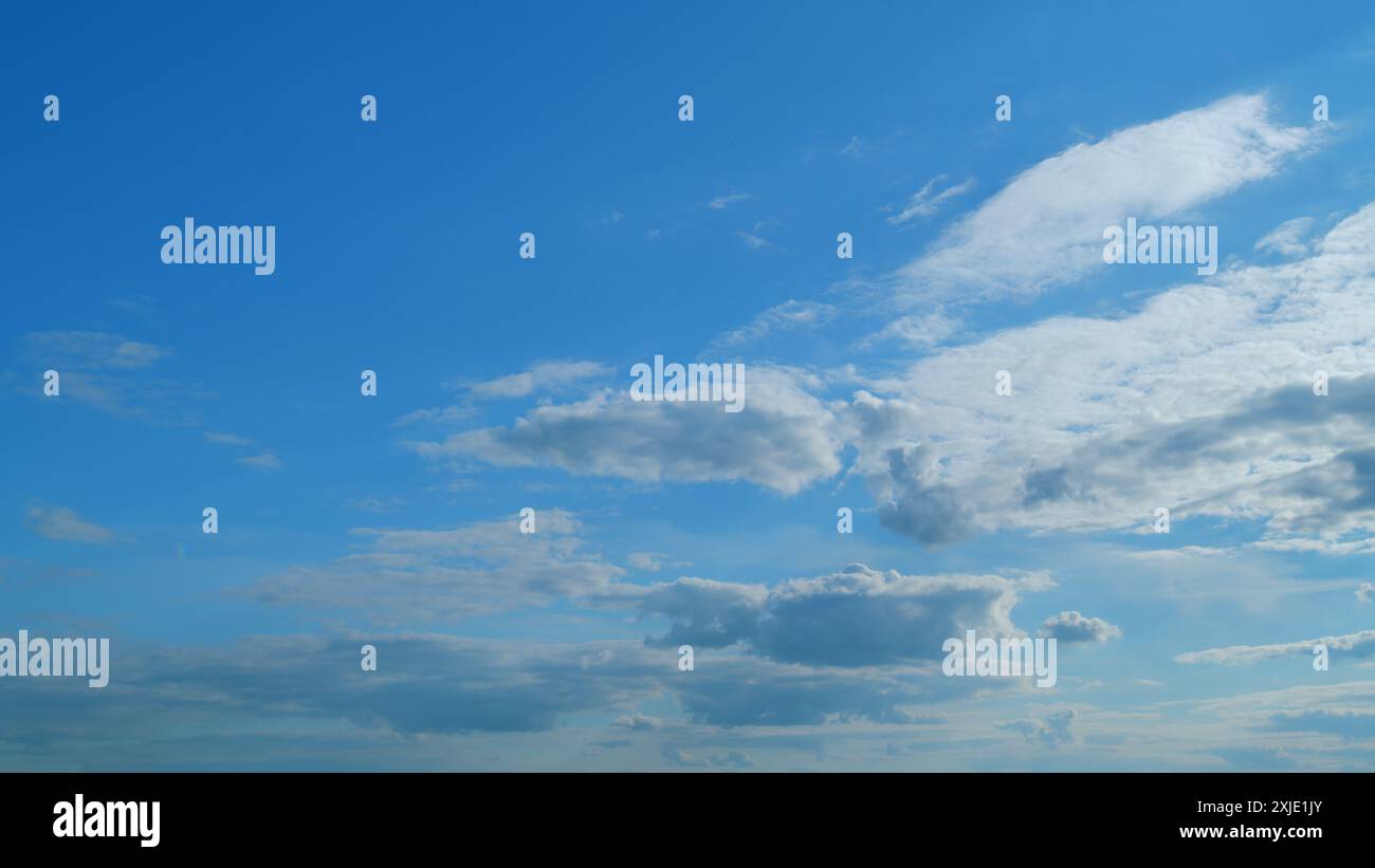 Time lapse. Clouds formation running across the blue sky. White puffy ...