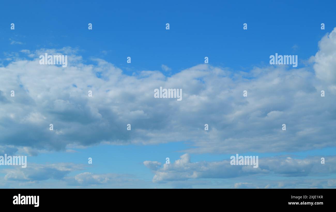 Time lapse. Puffy fluffy white cloud. Summer blue sky background Stock ...