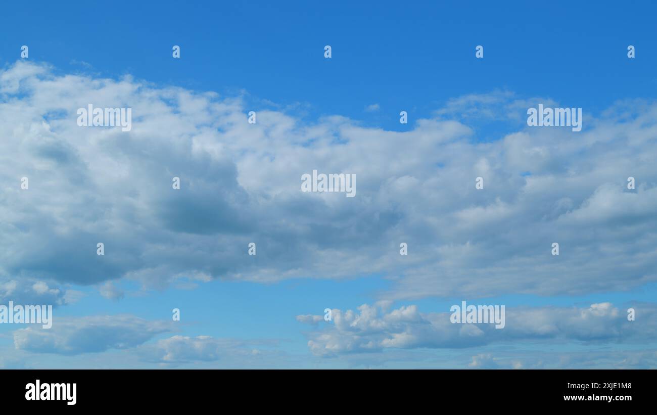 Time lapse. Fluffy curly rolling cloud in windy Summer weather. White ...