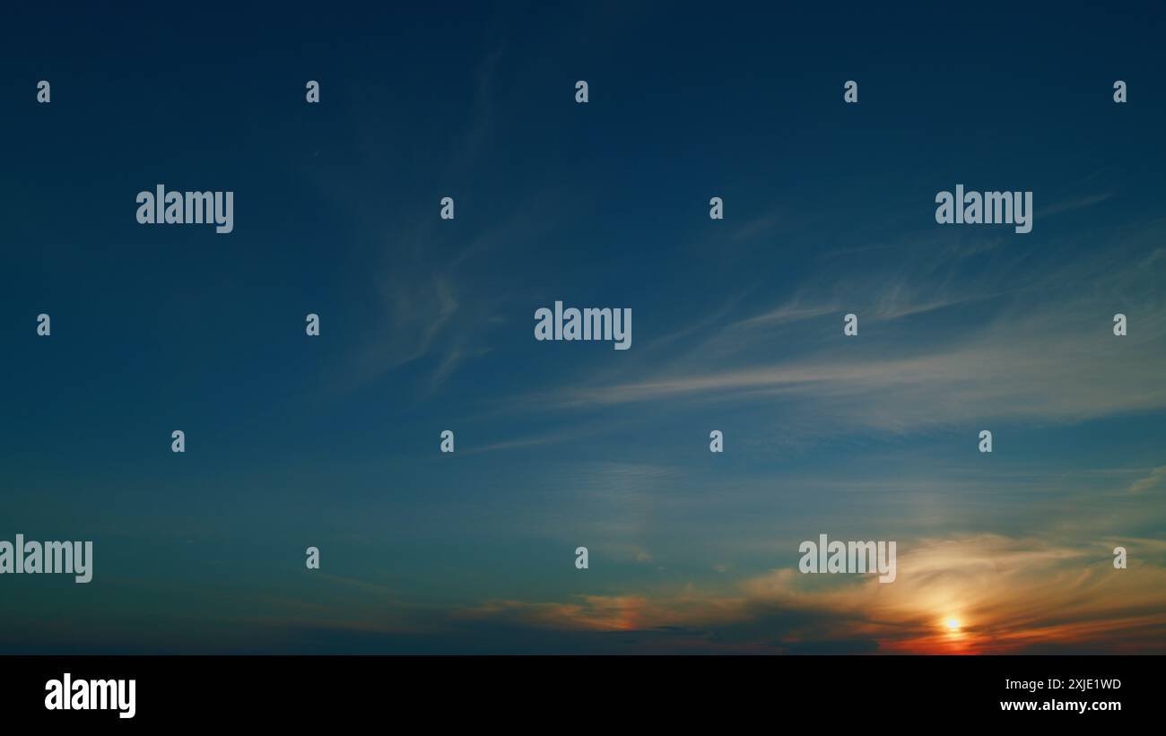 Time lapse. Halo is an optical phenomenon. Orange and blue clouds in ...