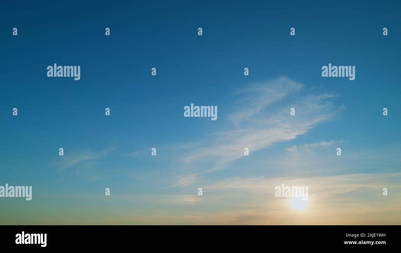 Time lapse. Sunset sky. Orange blue sunset sky clouds. Jet contrail as ...