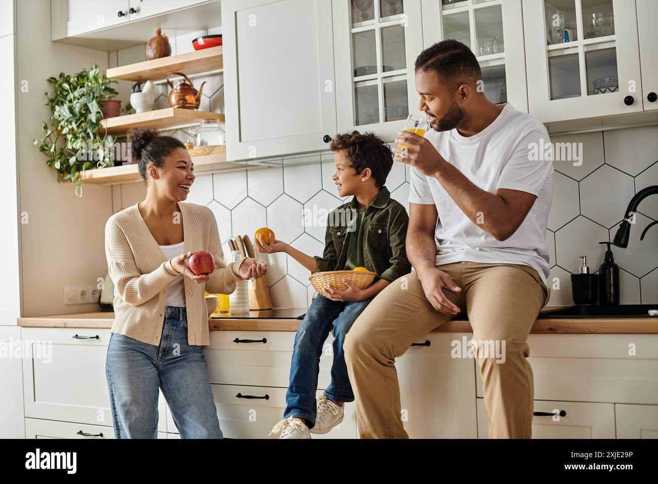 African American family enjoying a meal on kitchen counter together ...
