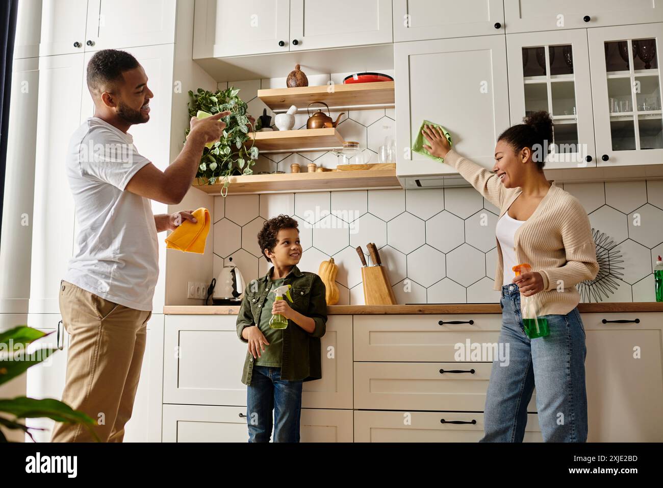 African american family happily cleaning together in the kitchen Stock ...