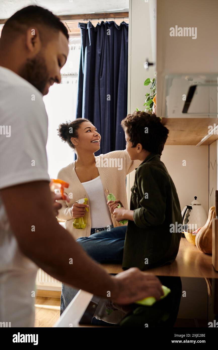 A loving African American family spending quality time together in a vibrant kitchen setting ...