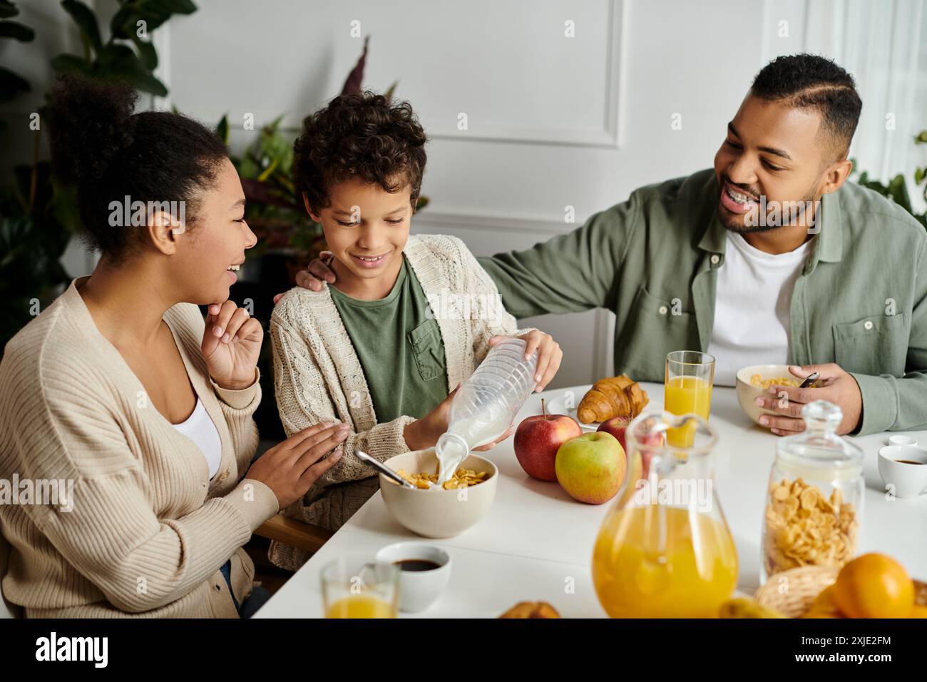 African american family enjoys a meal together at a table, fostering ...