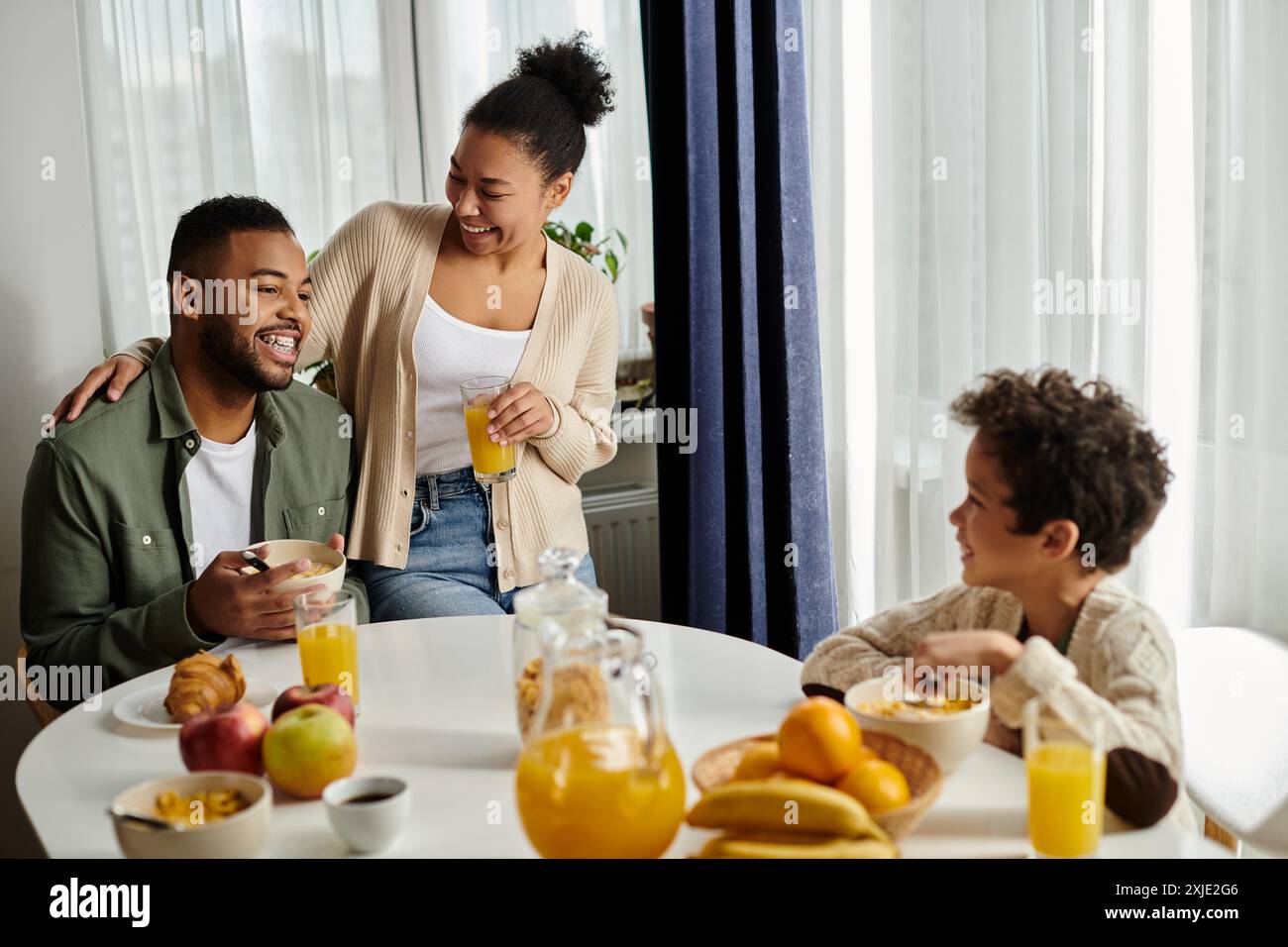 African american family at a table sharing a meal and enjoying each ...