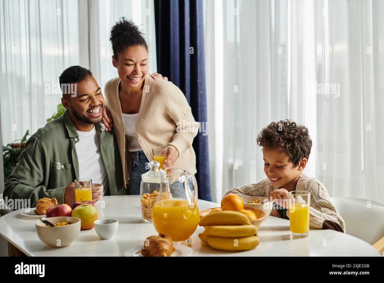African American family sharing a heartwarming breakfast together at ...