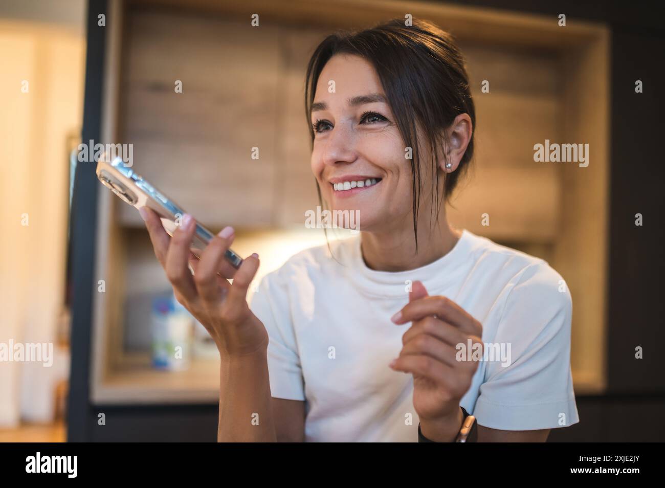 Cute smiling young woman at home having a call on the phone Stock Photo ...