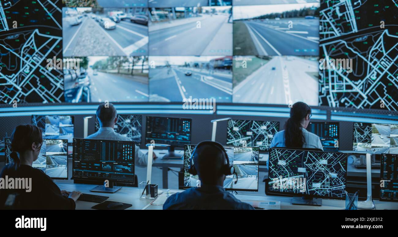 Dark Monitoring Room with Multiethnic Specialists Monitoring Surveillance Feeds and Coordinating ...