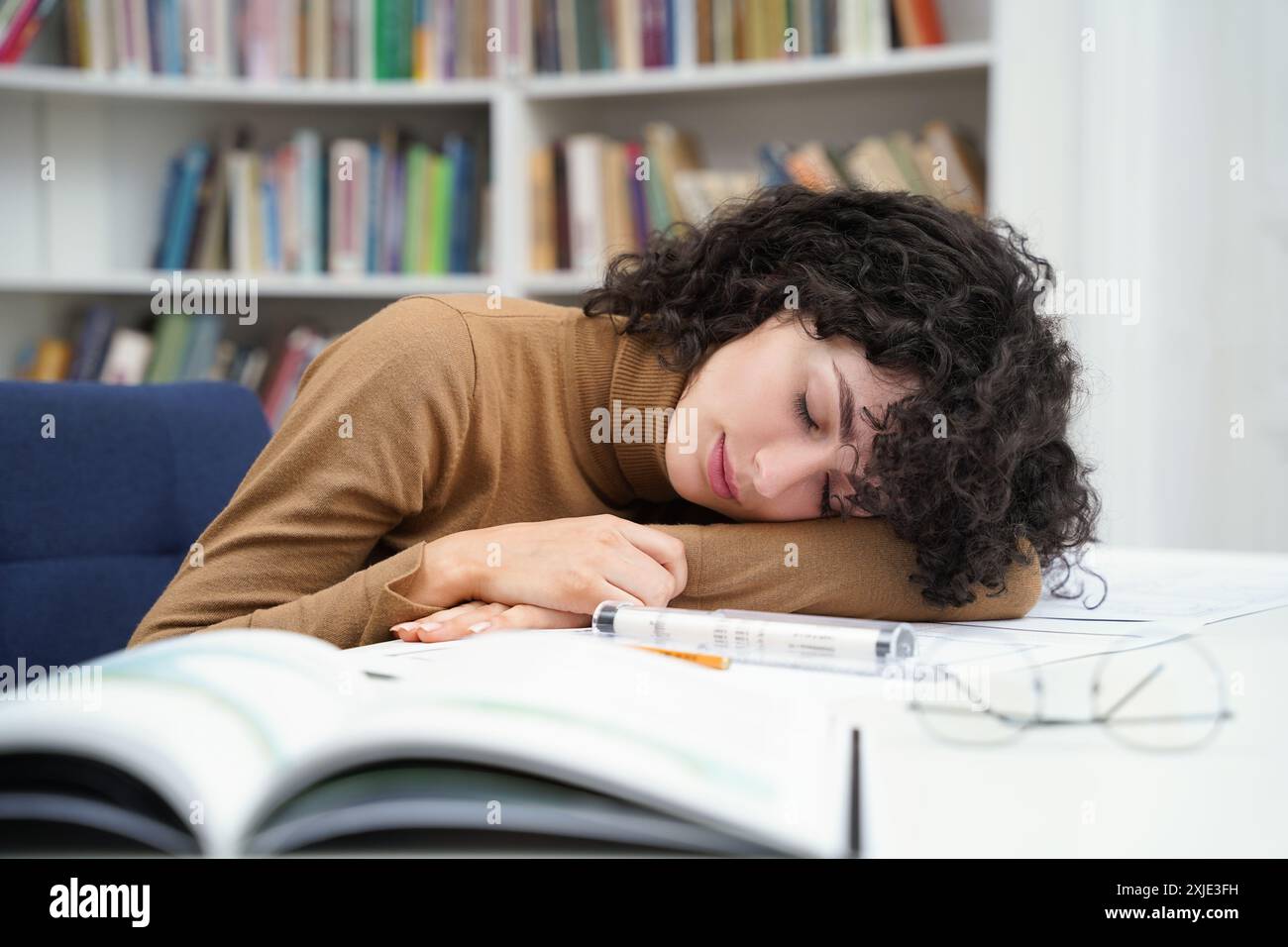Falling asleep in library hi-res stock photography and images - Alamy