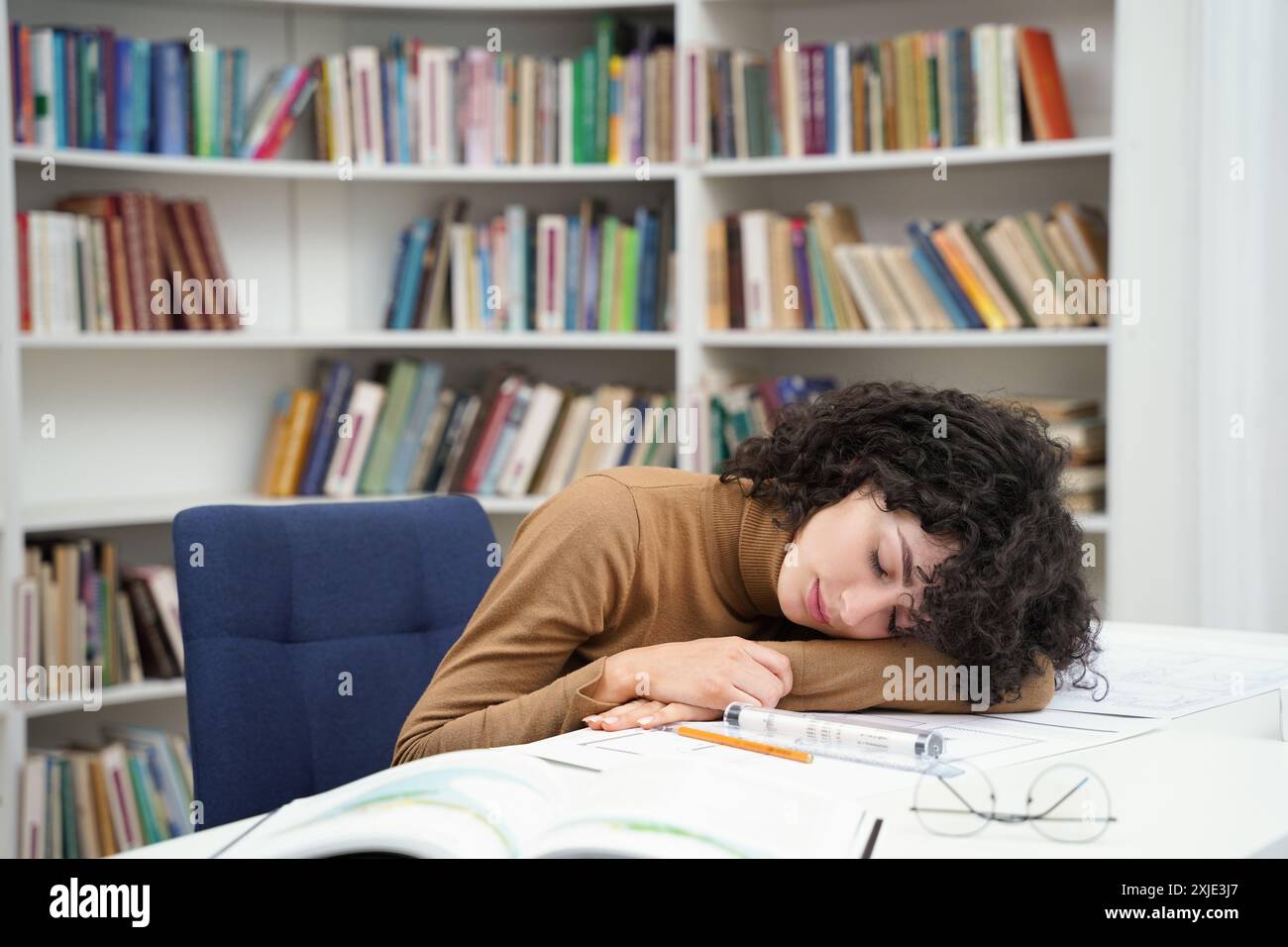 Falling asleep in library hi-res stock photography and images - Alamy