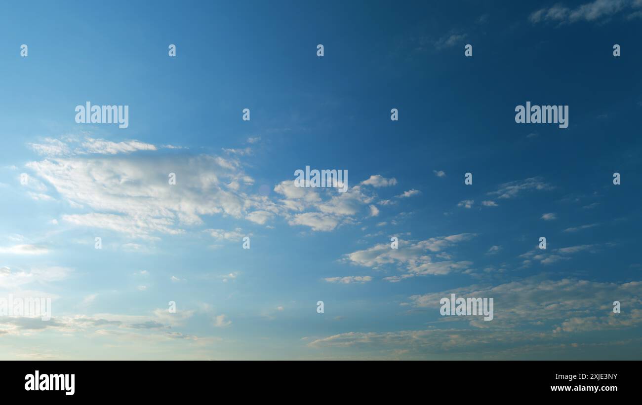 Time lapse. Clouds running across the blue sky. White puffy and fluffy ...