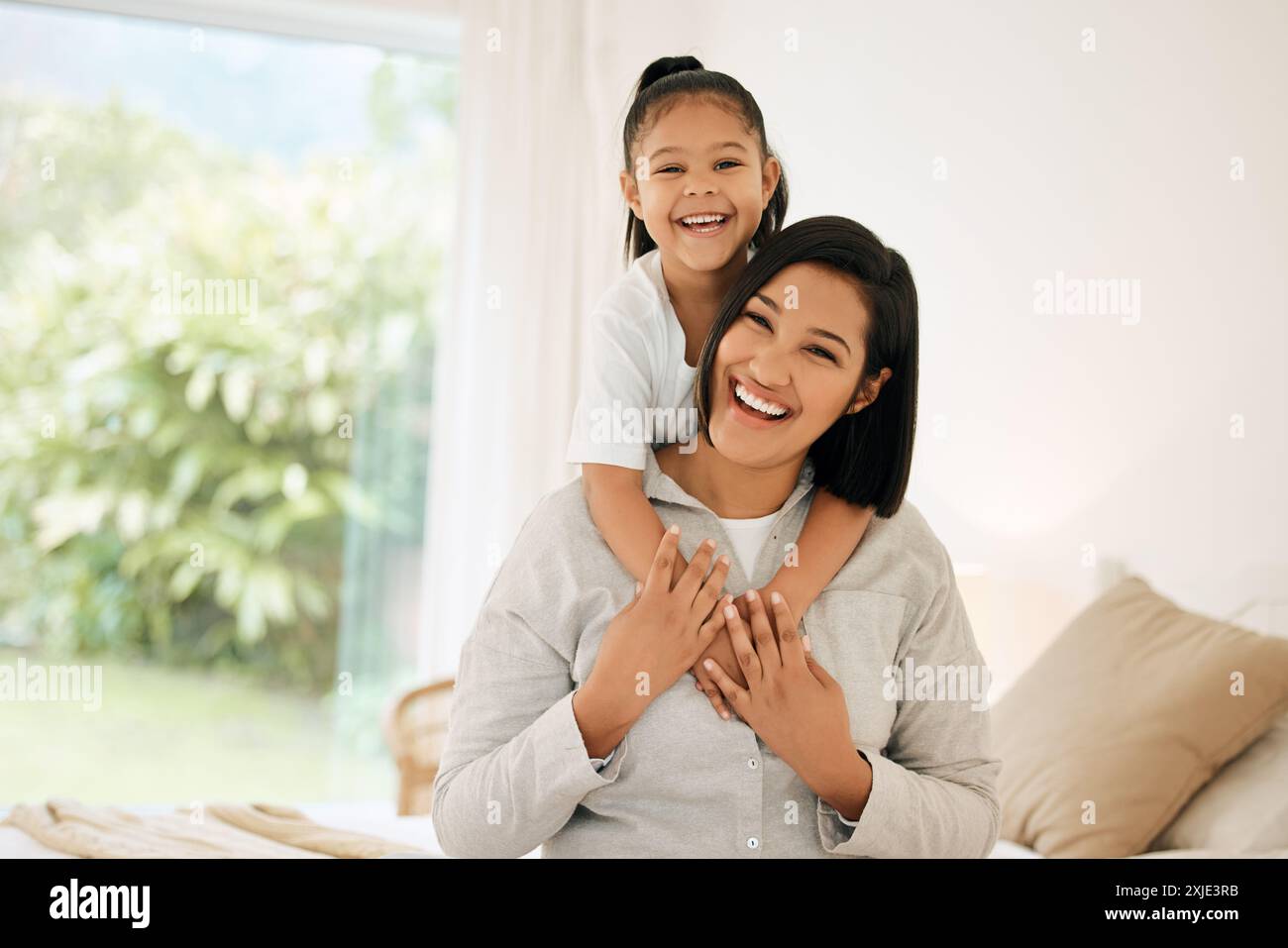 Happy mom, portrait and daughter with hug on bed for bonding, love or embrace at home. Mother ...