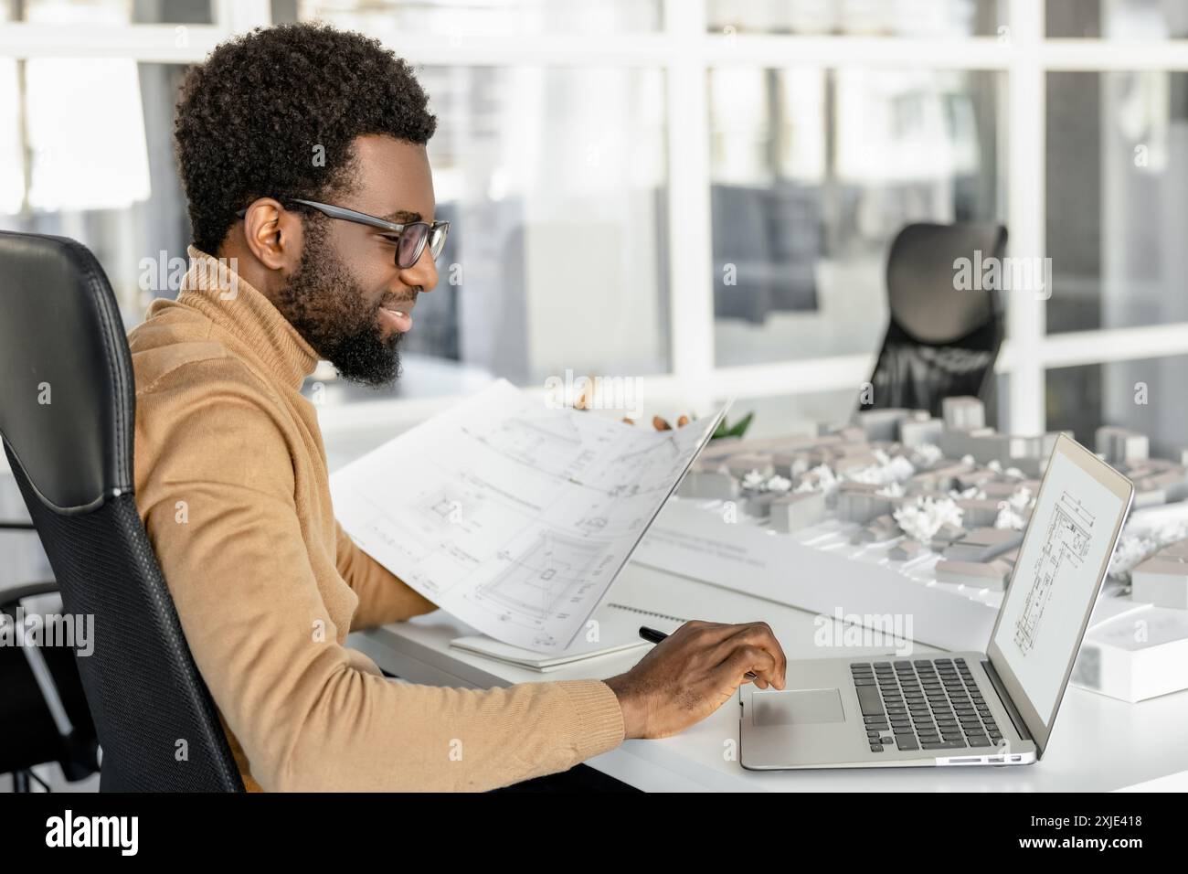 Expert man architect drawing blueprints in his workplace Stock Photo ...