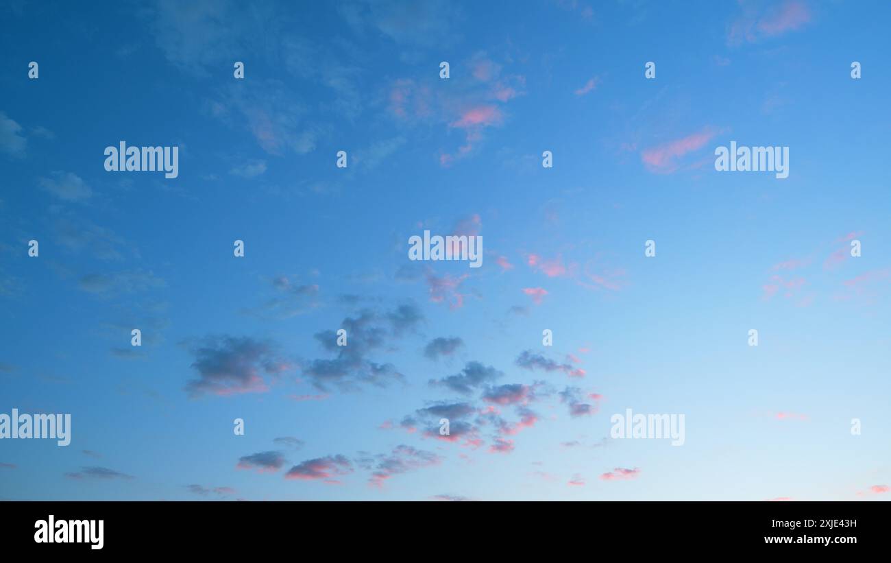 Time lapse. Pink purple fluffy clouds and blue sky. Weather forecast ...