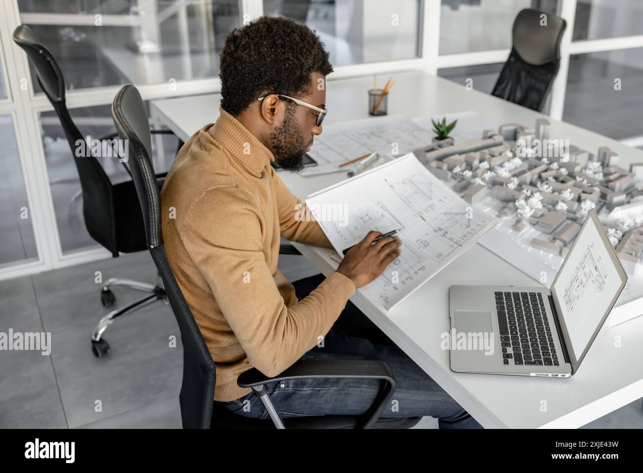 Professional man architect creating exterior designs in the workplace ...
