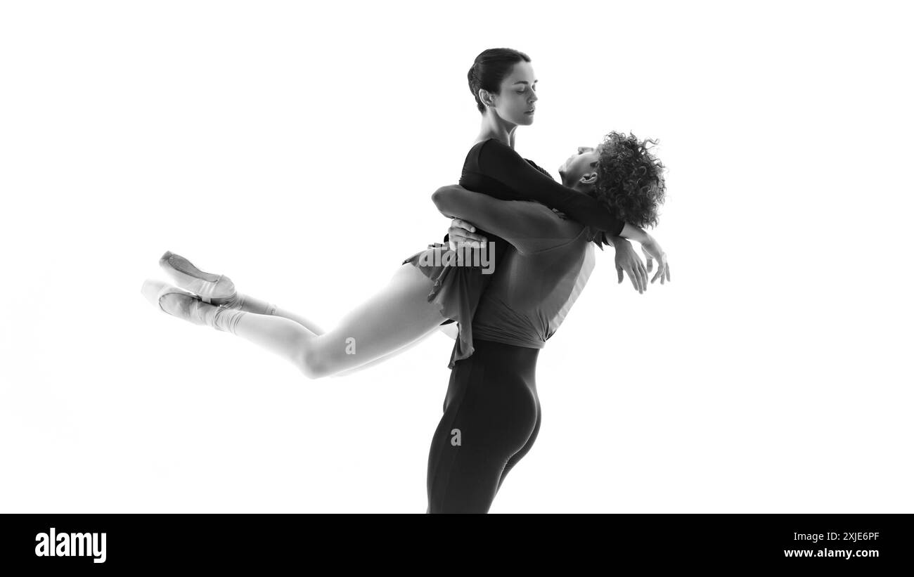 Synchronized elegance. Male and female ballet partners in practice ...