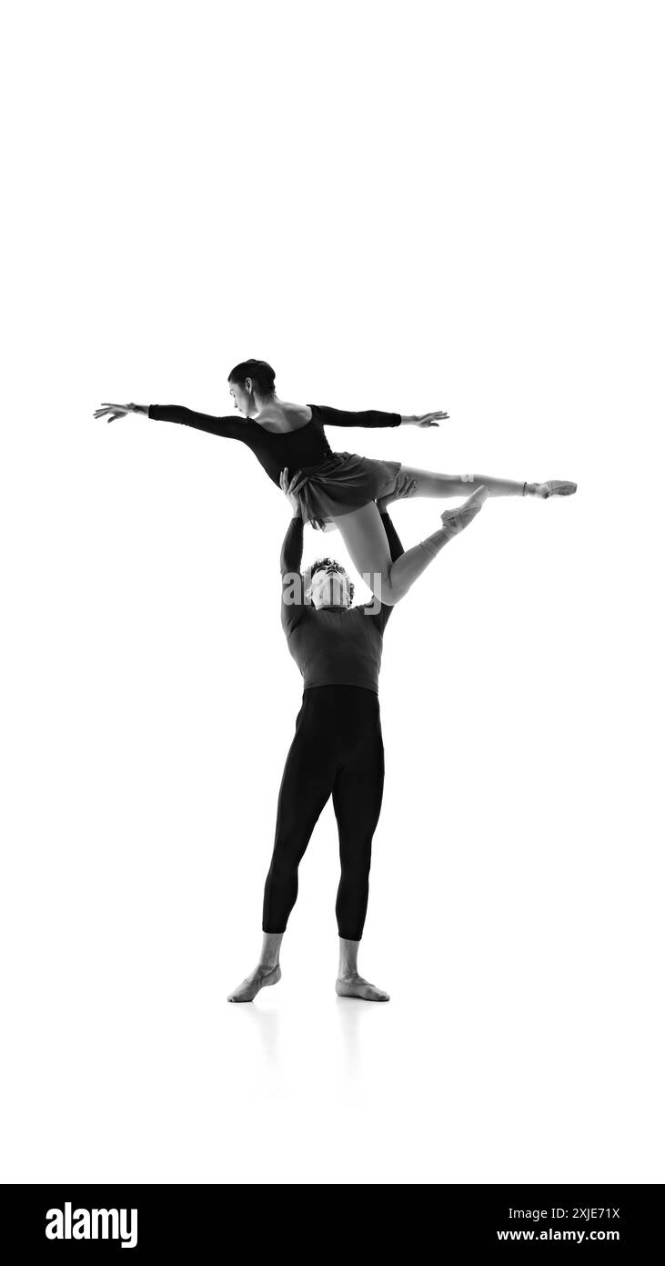 Ballet dancers in pair refining their technique in perfect harmony ...